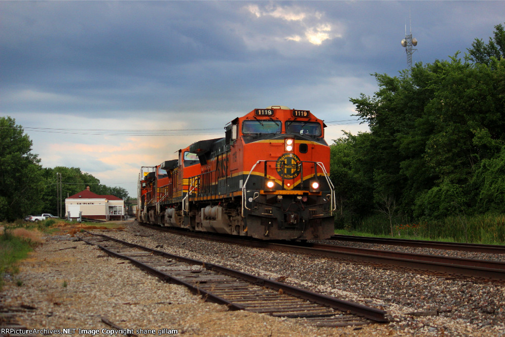 BNSF 1119 leads a Wb stack train Thur la Plata racing the storms.